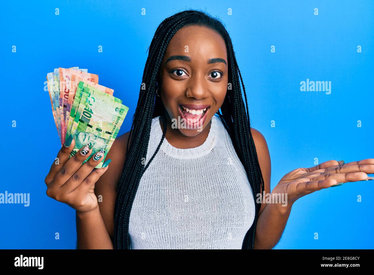 Young african american woman holding south african rand banknotes ...