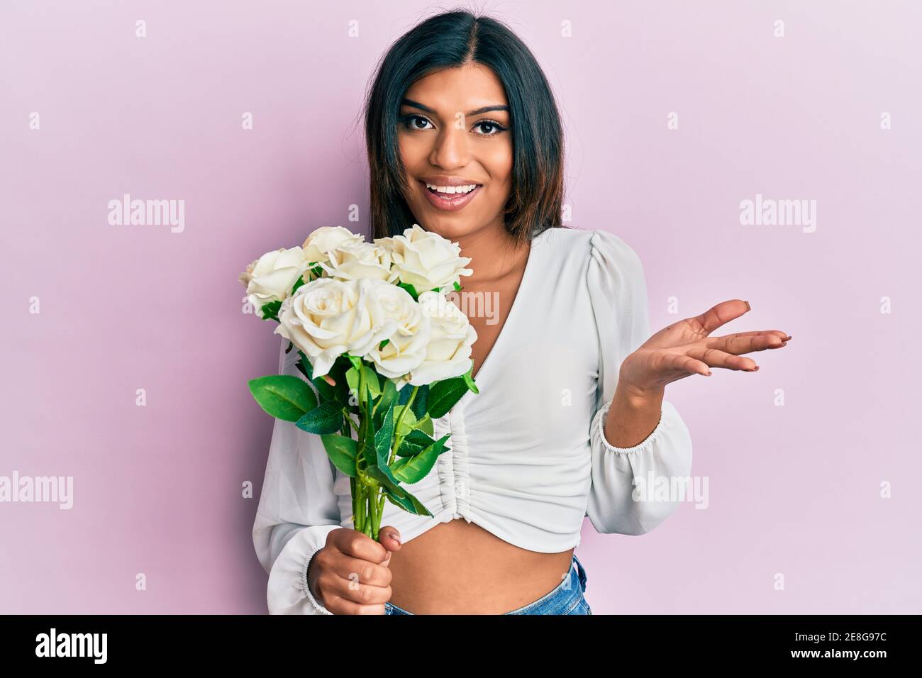 Young latin transsexual transgender woman holding flowers celebrating ...