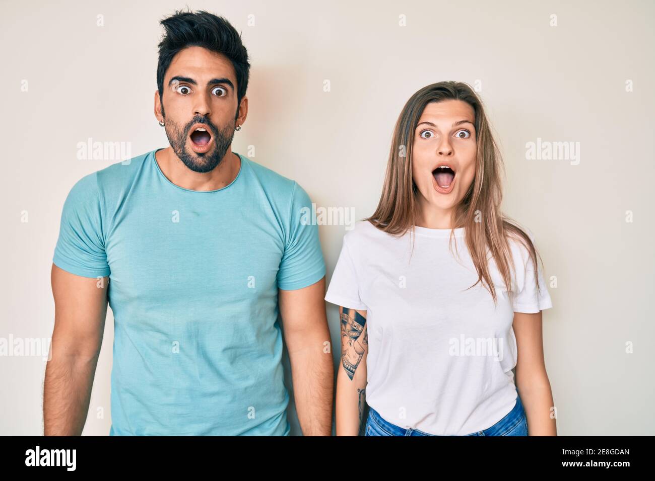 Beautiful young couple of boyfriend and girlfriend together afraid and ...