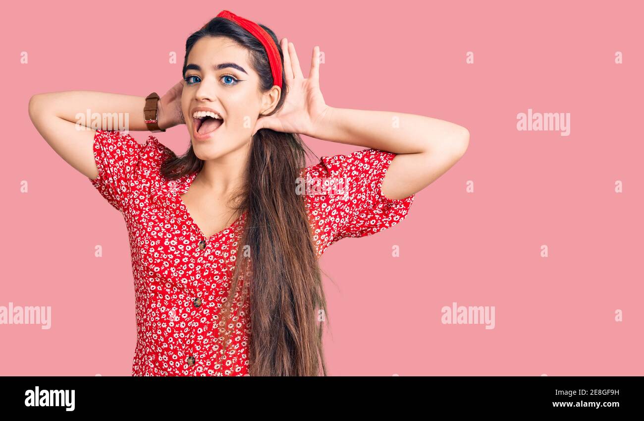 Brunette teenager girl wearing summer dress smiling cheerful playing ...