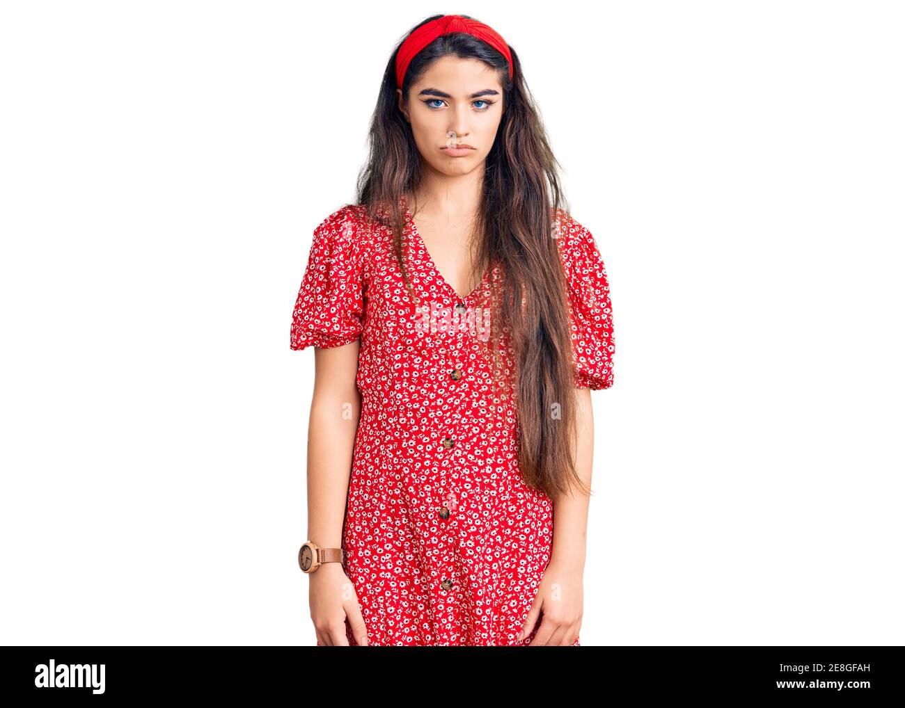 Brunette teenager girl wearing summer dress depressed and worry for ...