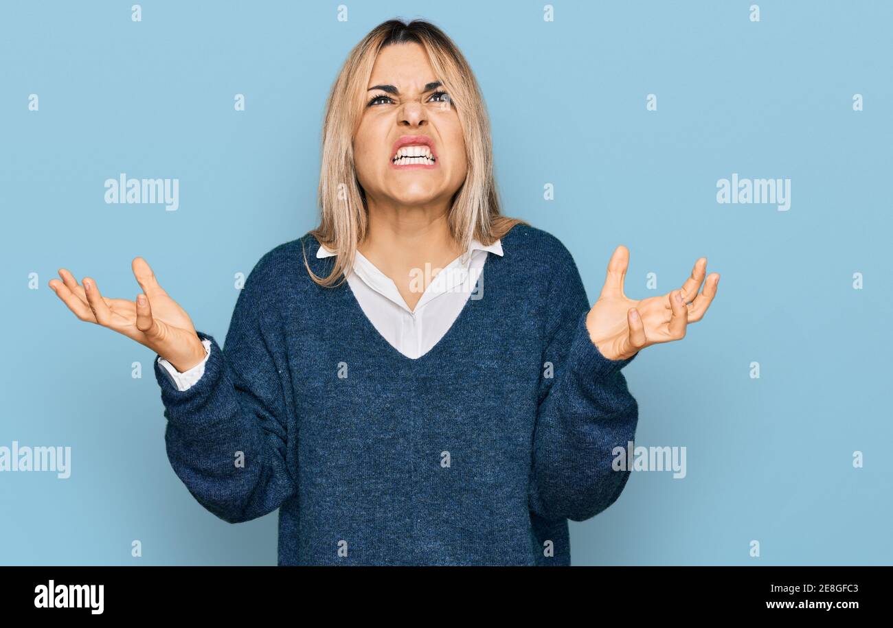 Young caucasian woman wearing casual clothes crazy and mad shouting and ...