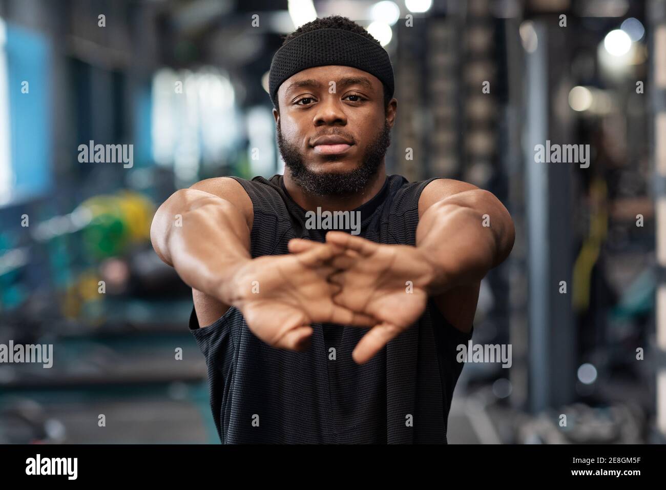 Sportsman stretching his hands before workout training at gym Stock ...