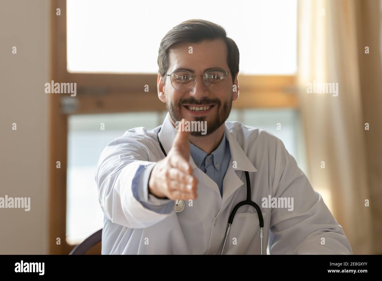 Portrait of smiling male doctor stretch hand for handshake Stock Photo ...