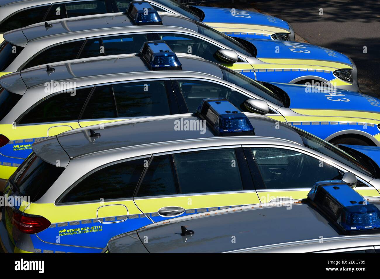 Several marked police cars in Germany standing side by side. Top view ...