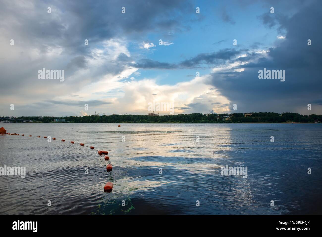 Buoys line the safe swimming area on the river on a summer evening ...