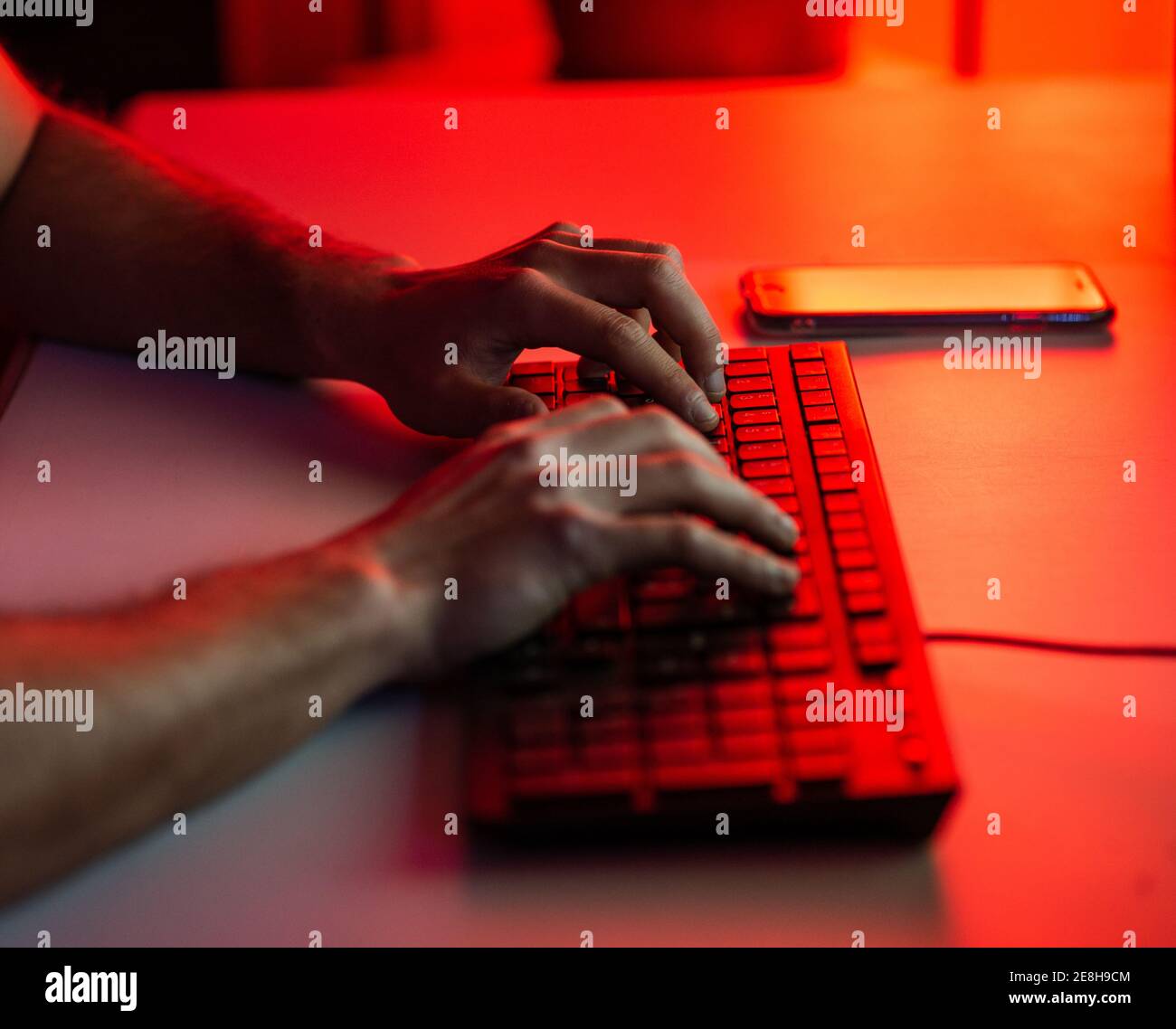 Crop anonymous male typing on keyboard while working on computer and ...