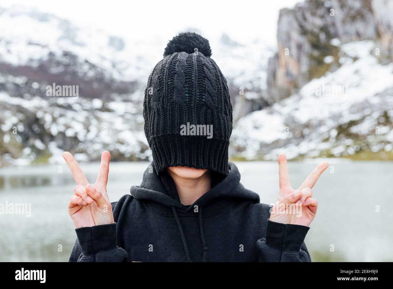 Hiding face behind fingers hi-res stock photography and images - Alamy