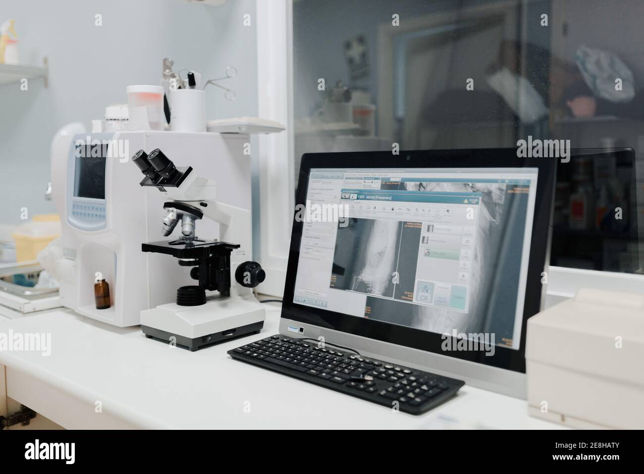 From above of microscope near computer with open program on screen in ...