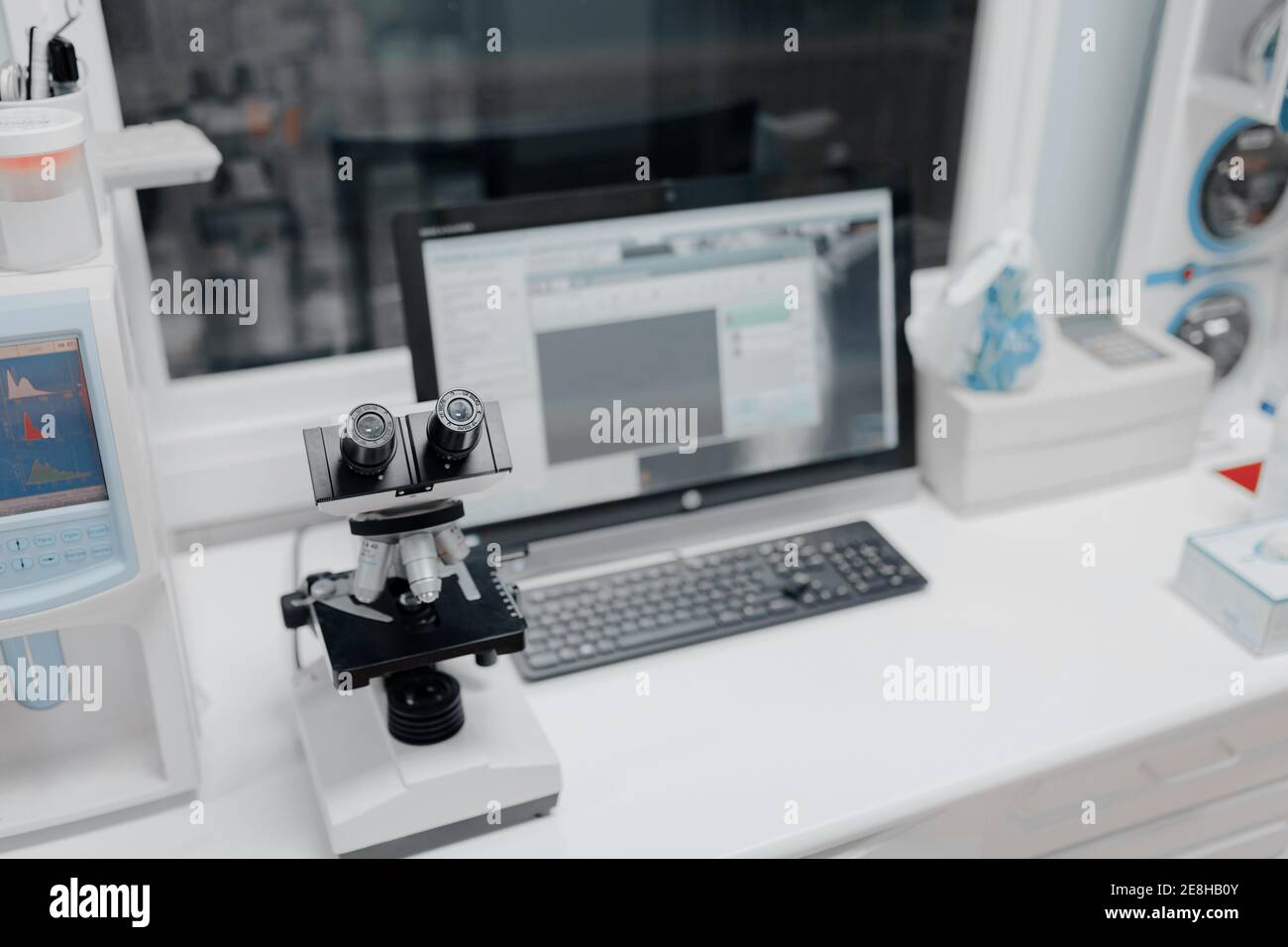 From above of microscope near computer with open program on screen in ...