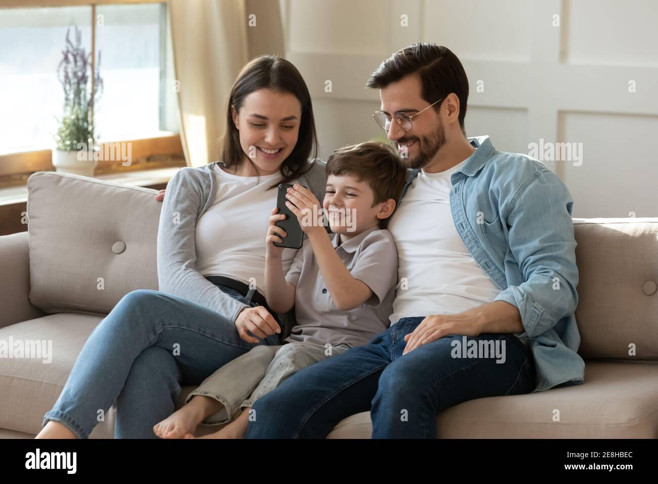 Happy family with small son use cellphone together Stock Photo - Alamy