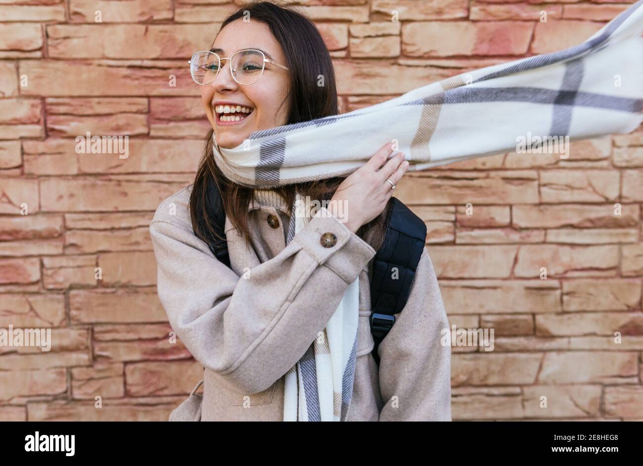 Student putting on his coat hi-res stock photography and images - Alamy