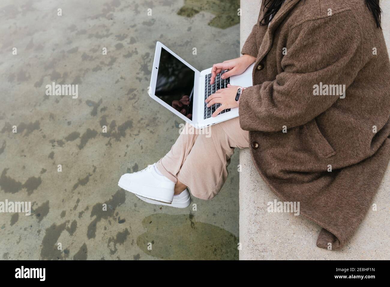 From above side view of crop anonymous plus size female surfing ...
