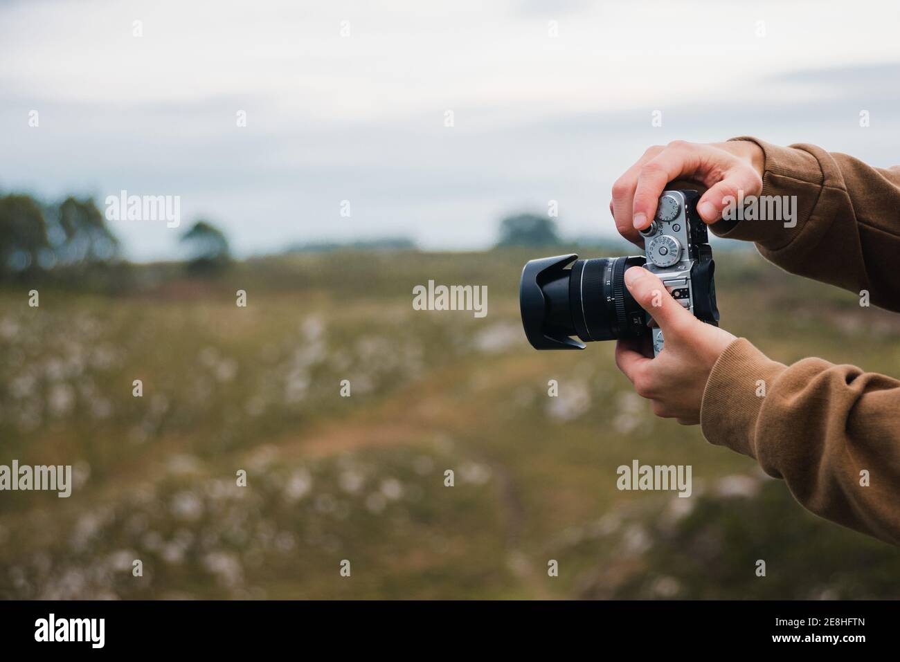 Crop anonymous male photographer in warm jacket taking pictures on ...