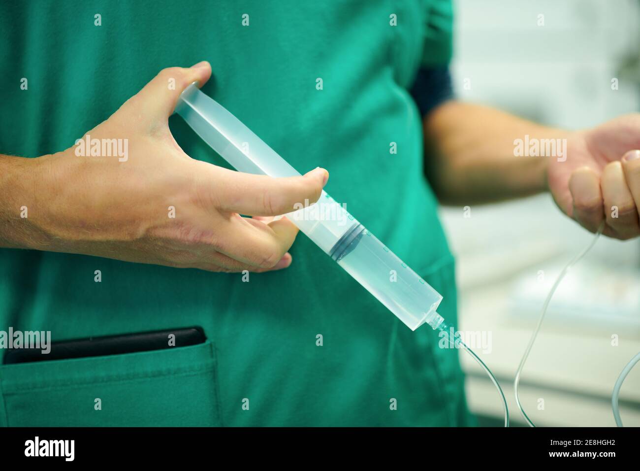 Crop anonymous doctor in medical uniform filling infusion drip with ...