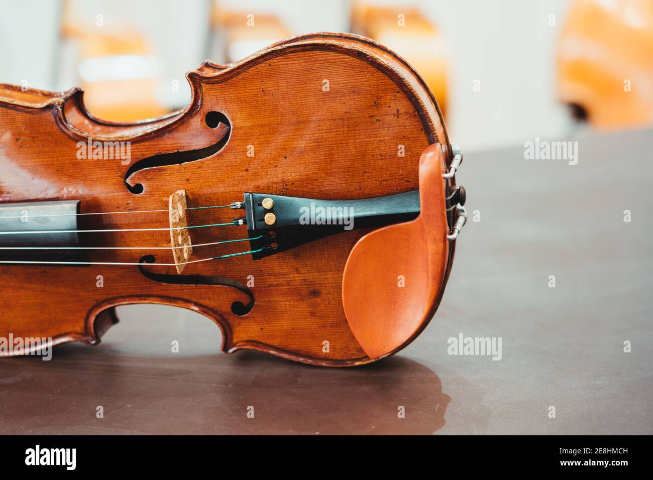 Modern shiny violin placed on shabby wooden table in workshop Stock ...