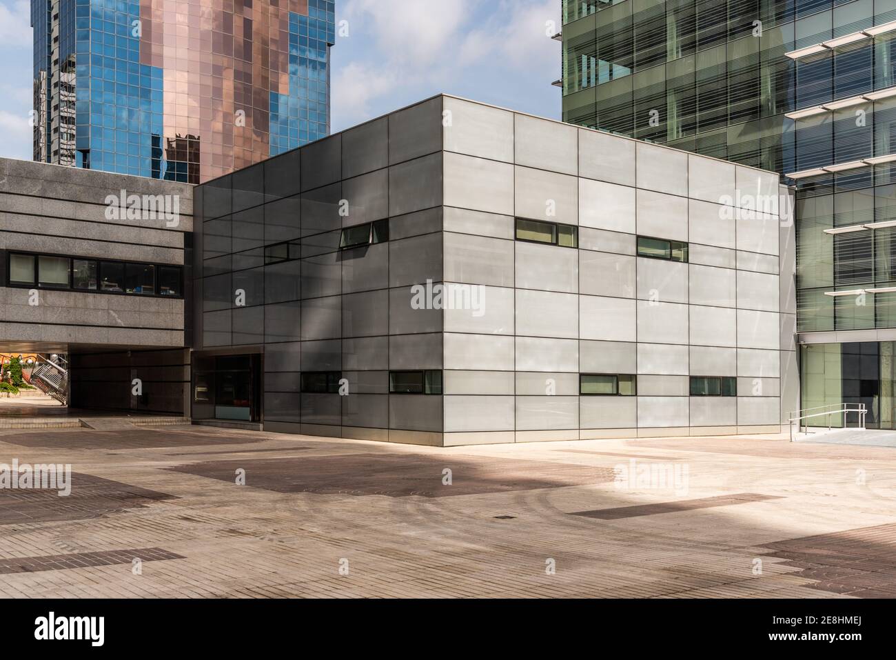 Modern skyscraper and rectangular shaped construction on urban pavement ...