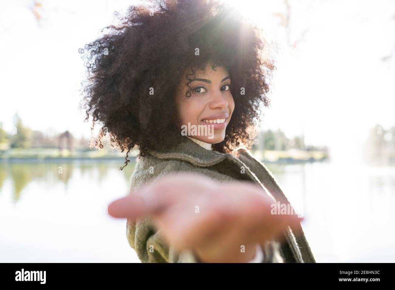 Young woman reaching hand towards sun hi-res stock photography and ...