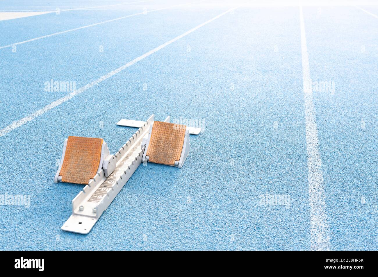 High angle of starting blocks placed on blue track at stadium before ...