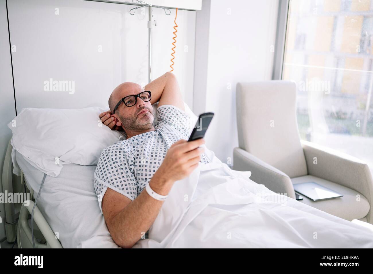 Male patient in hospital gown hi-res stock photography and images - Alamy