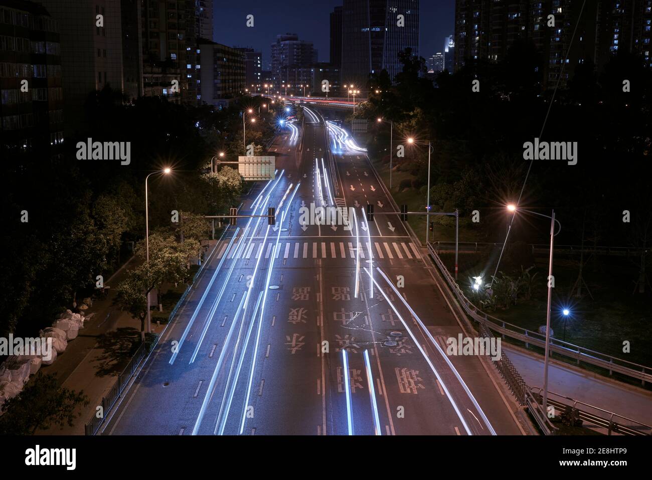 Long exposure busy asphalt road with driving vehicles in contemporary ...