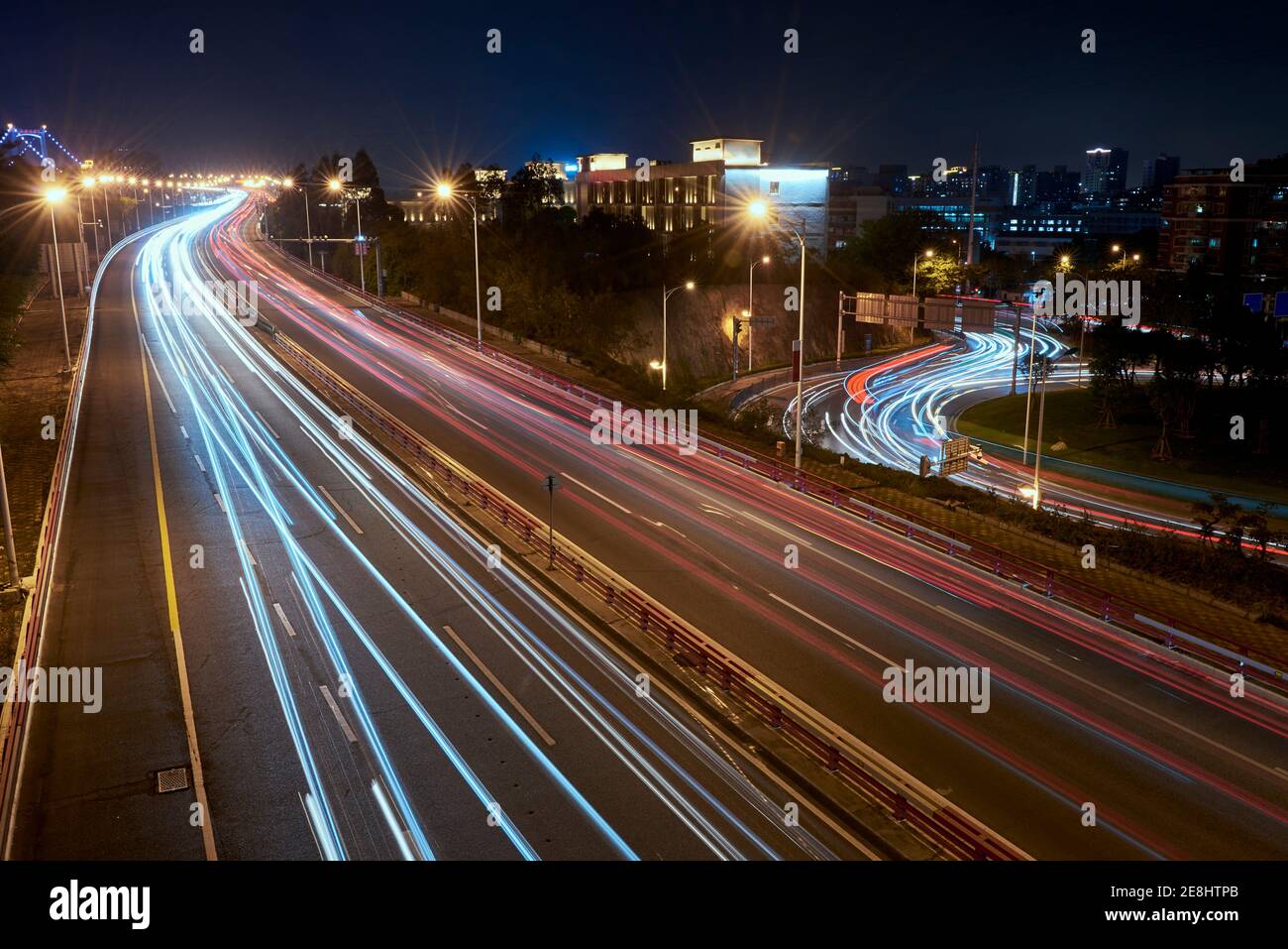 Long exposure busy asphalt road with driving vehicles in contemporary ...