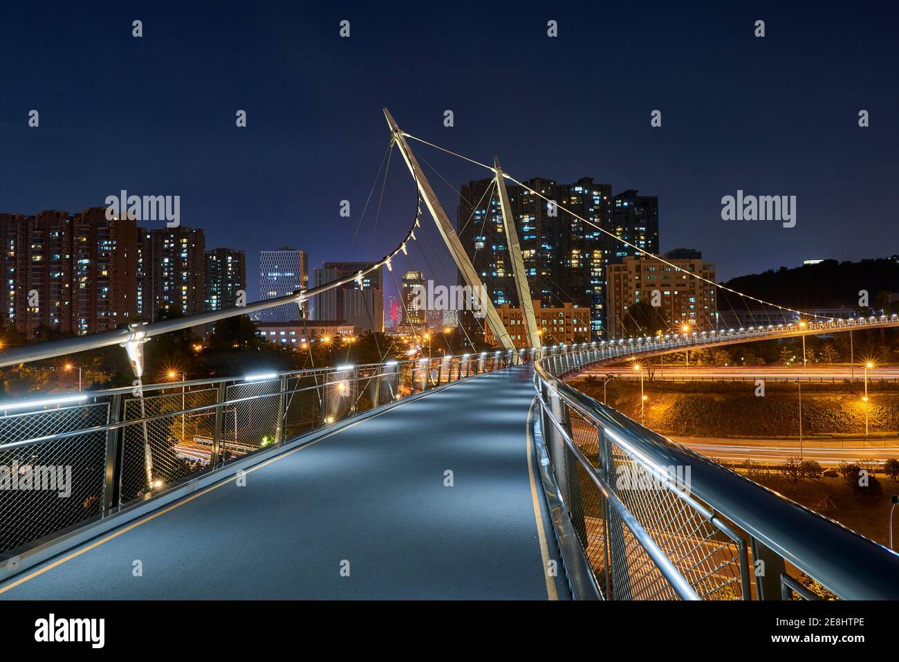 Contemporary suspension pedestrian bridge in creative design crossing ...