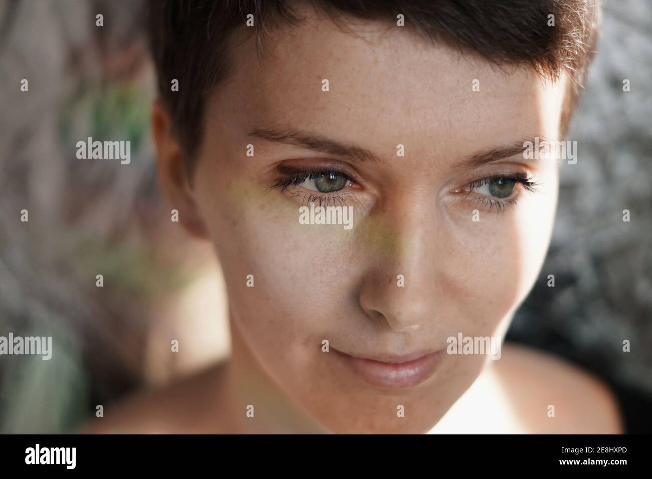 Crop feminine thoughtful adult lady with natural makeup and short hair ...