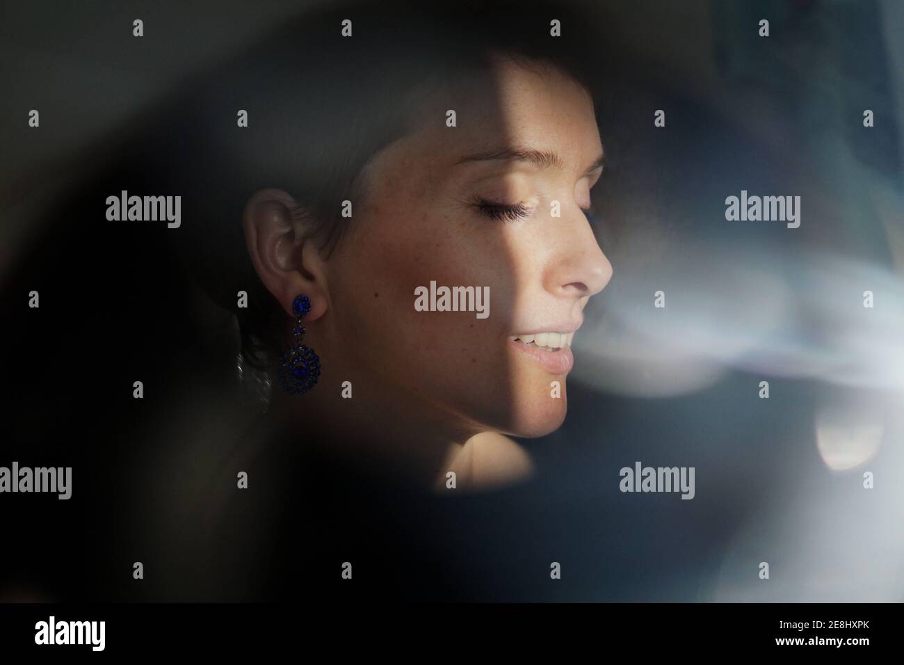 Through glass of peaceful happy adult lady with short hair recreating ...