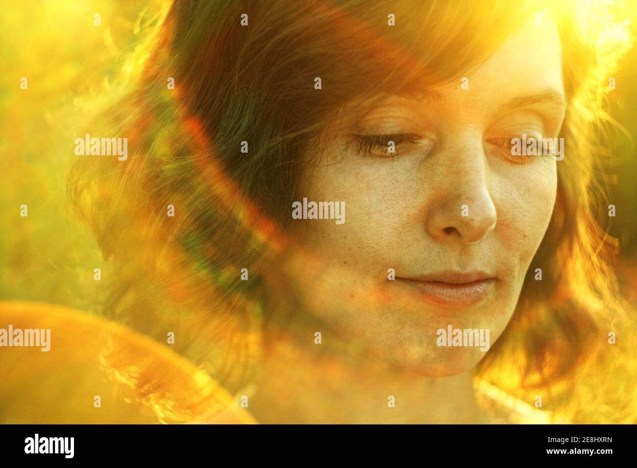 Crop thoughtful adult female resting in nature and looking down ...