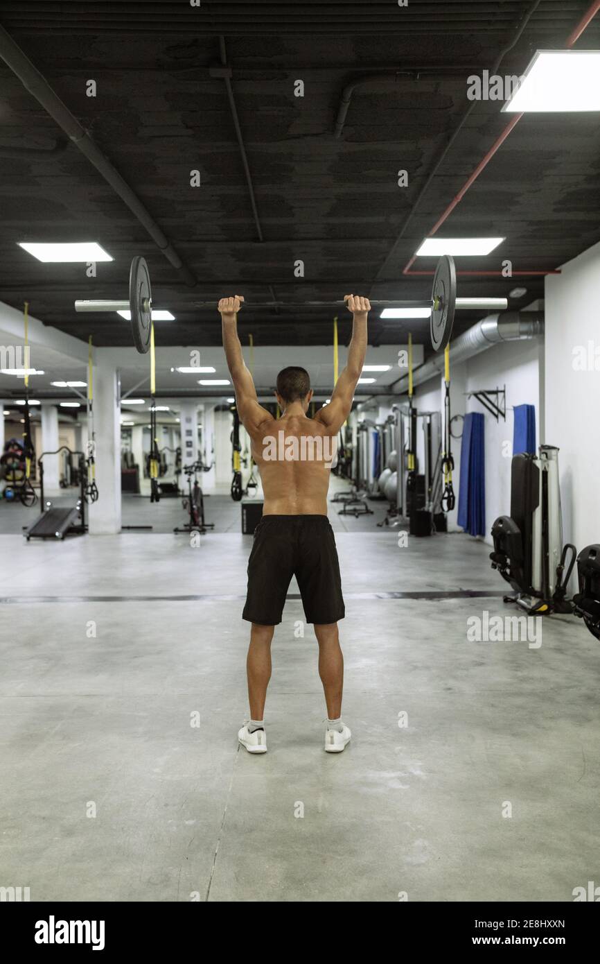 Back view of full body of strong young muscular male athlete in ...
