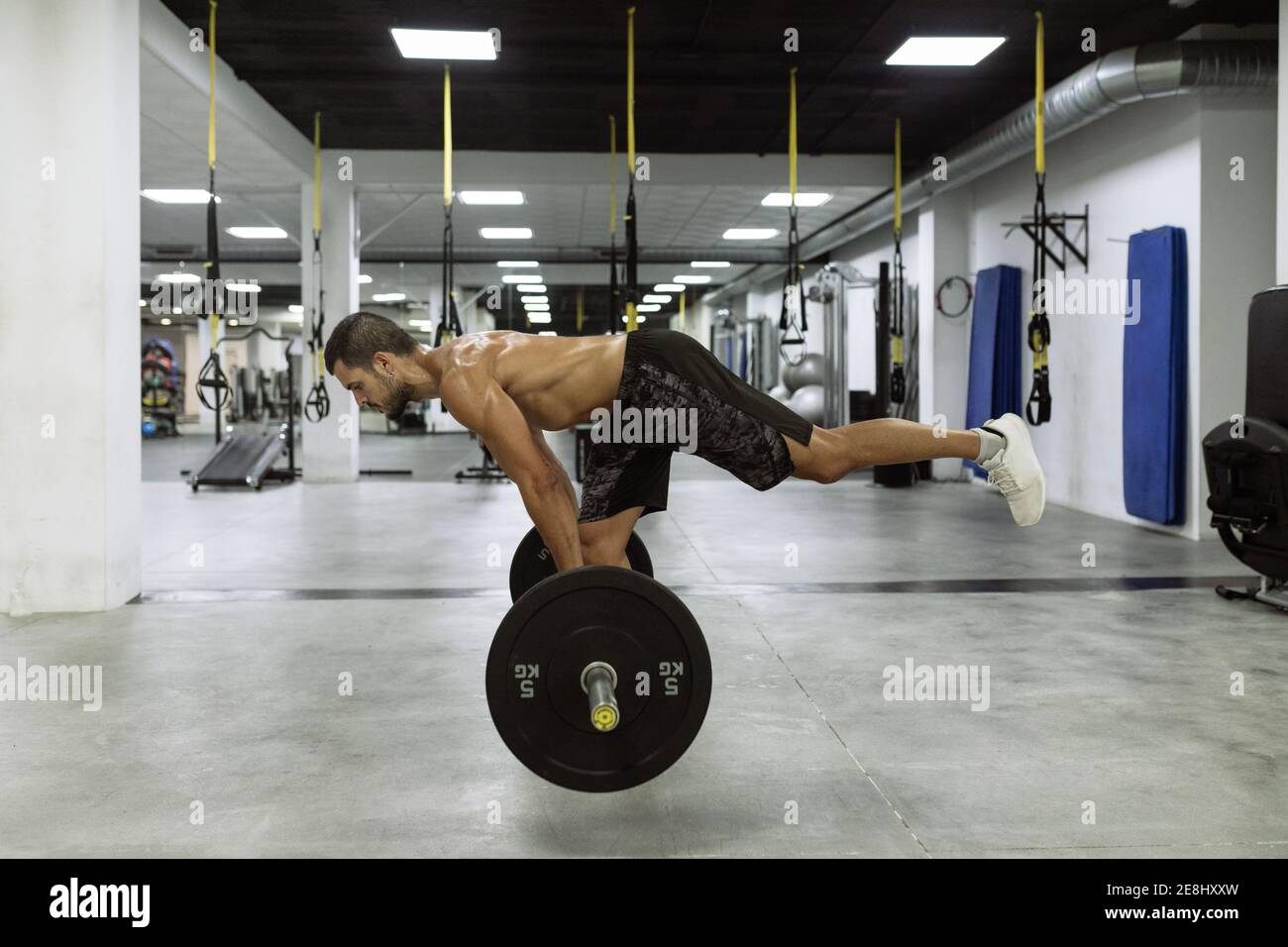 Side view of full body of strong young muscular male athlete in ...
