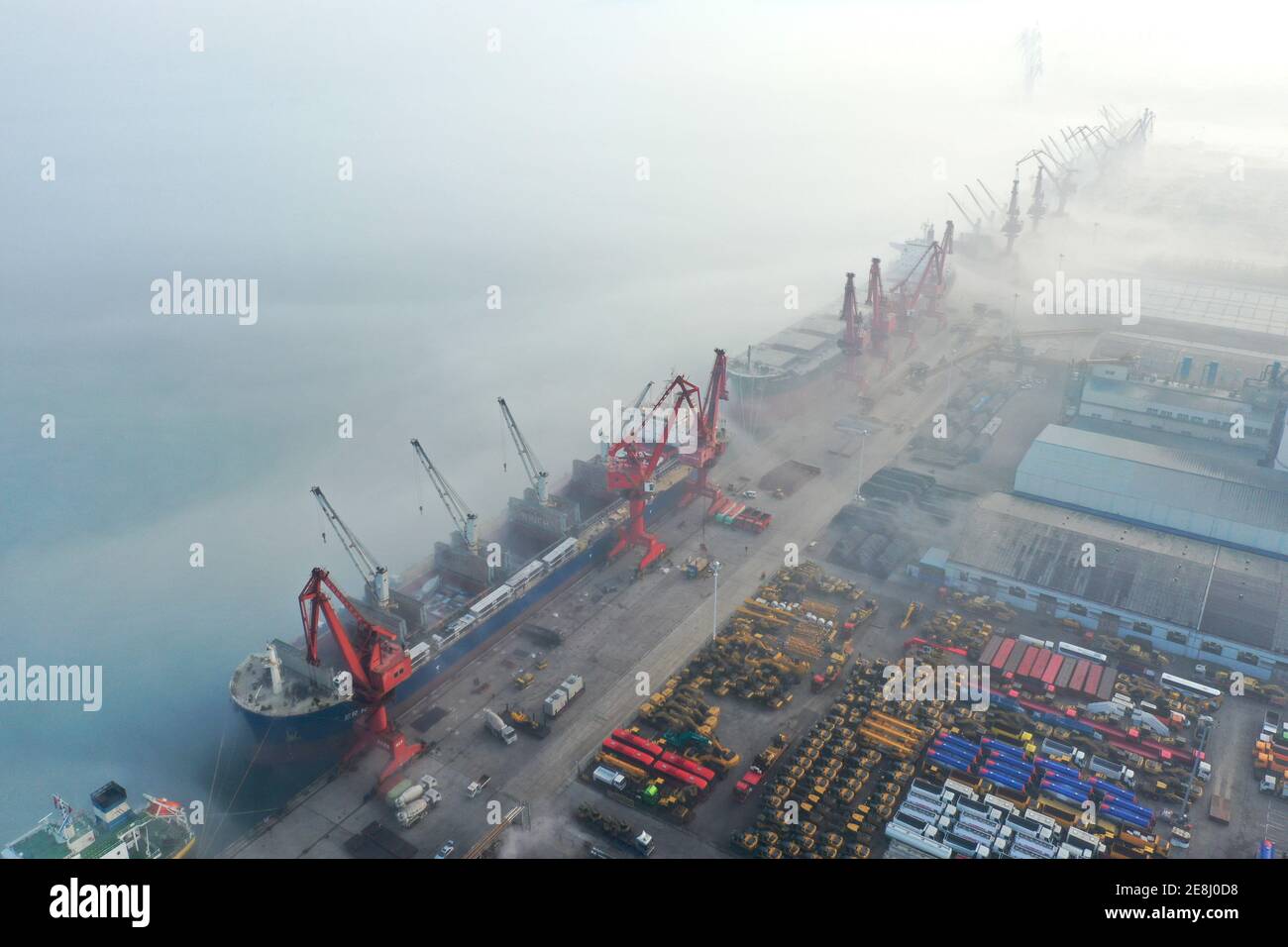 LIANYUNGANG, CHINA - JANUARY 31, 2021 - Lianyungang wharf is seen under advection fog in ...