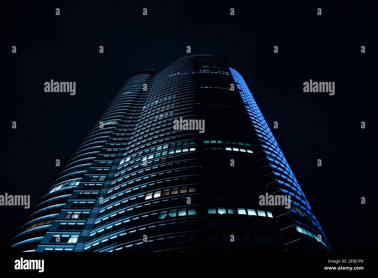 From below view of high illuminated skyscrapers tower in big city at ...