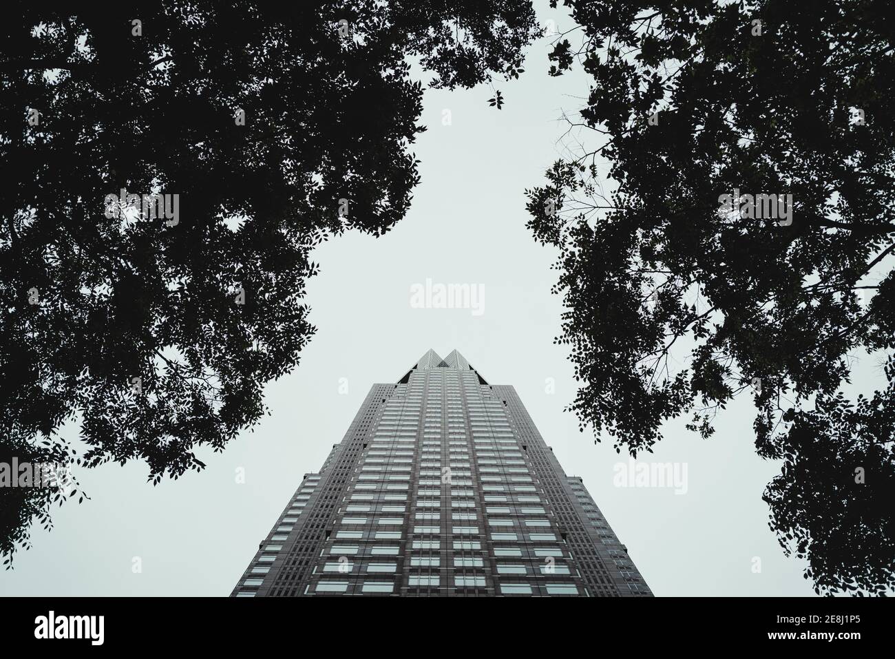 From below view to high skyscrapers towers and small buildings in big ...