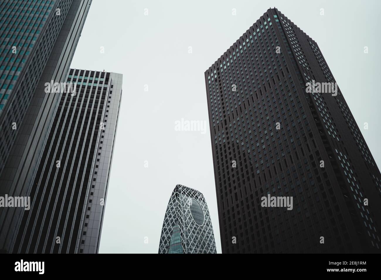 View to high skyscrapers towers and small buildings in big city Stock ...