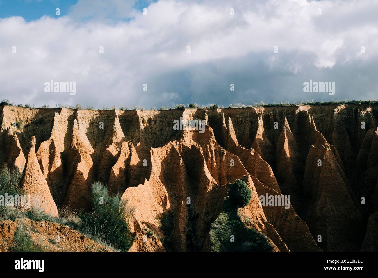 Scenery view of gorge with dry surface surrounded by green mount on ...