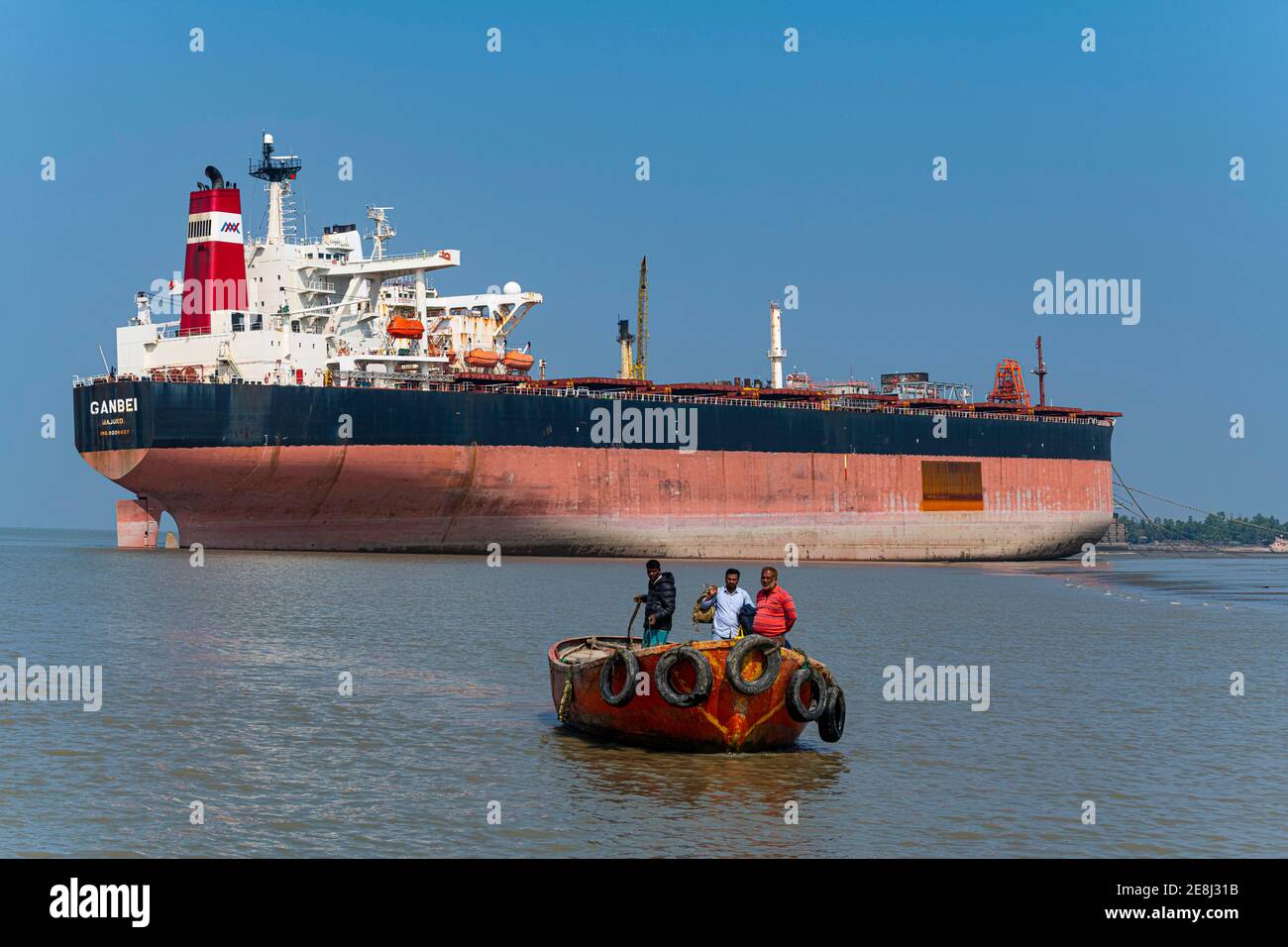 Little boat under a Huge container ship ready to break up, Chittagong ...