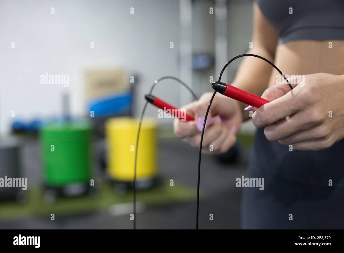 Crop unrecognizable slim female in sportswear doing exercise with ...