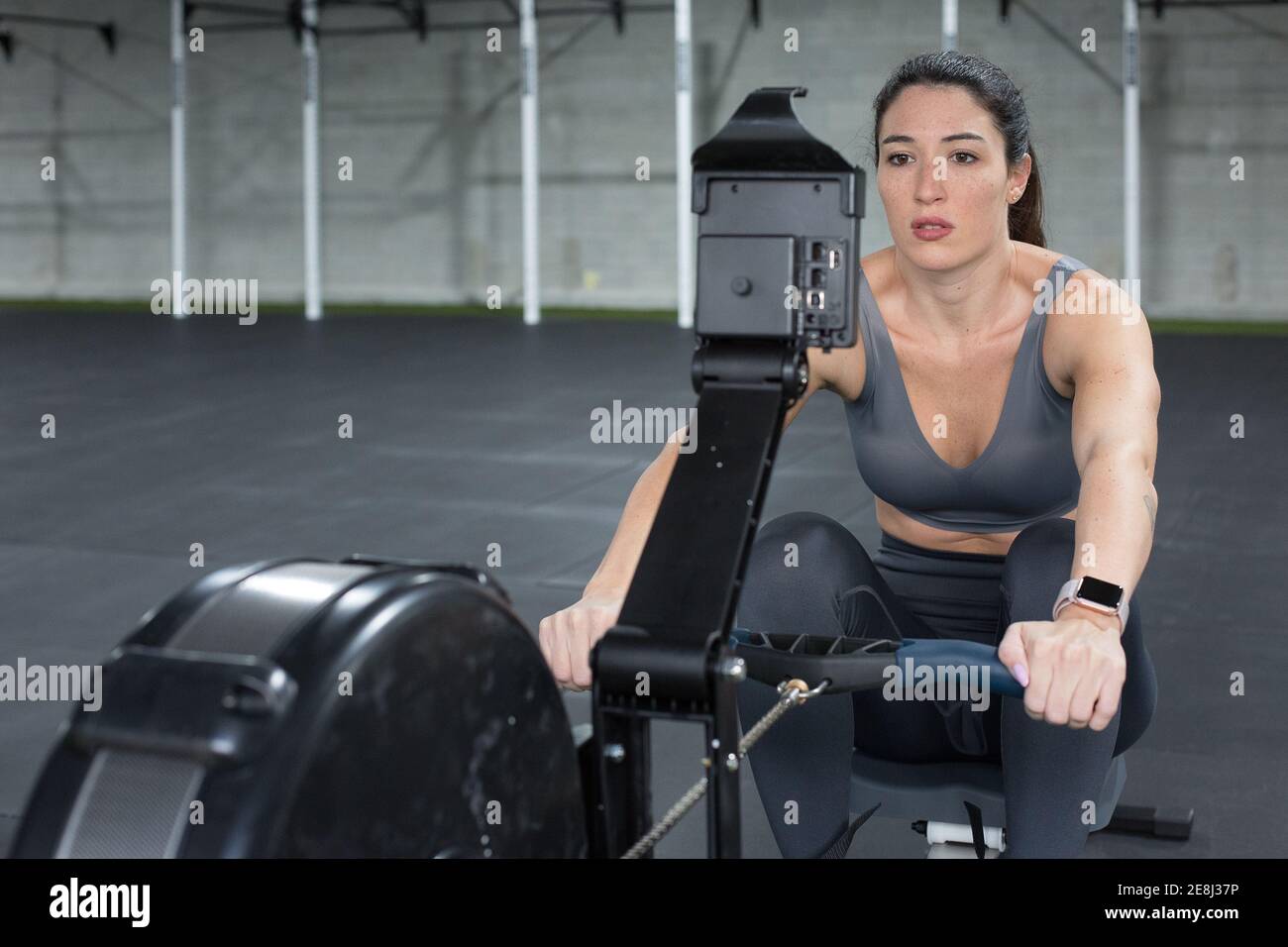 Woman doing exercise on rowing hi-res stock photography and images - Alamy