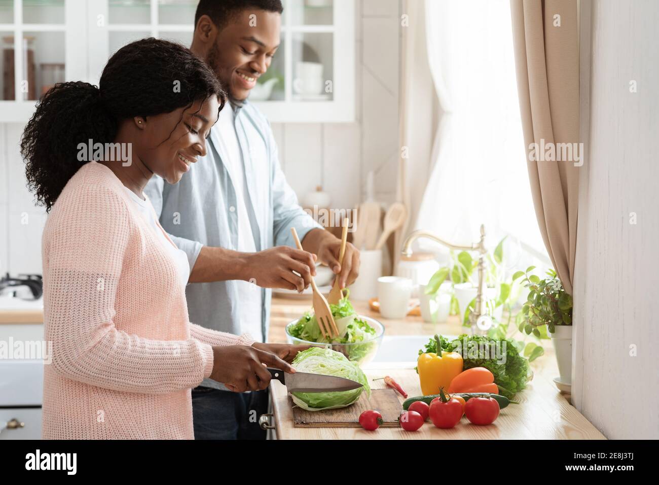 Attractive couple cooking together hi-res stock photography and images ...