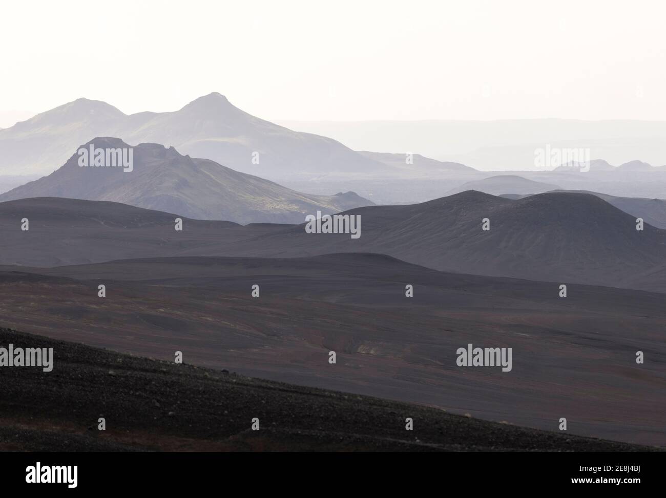 Picturesque scenery of rough mountain range with peaks in dense fog ...
