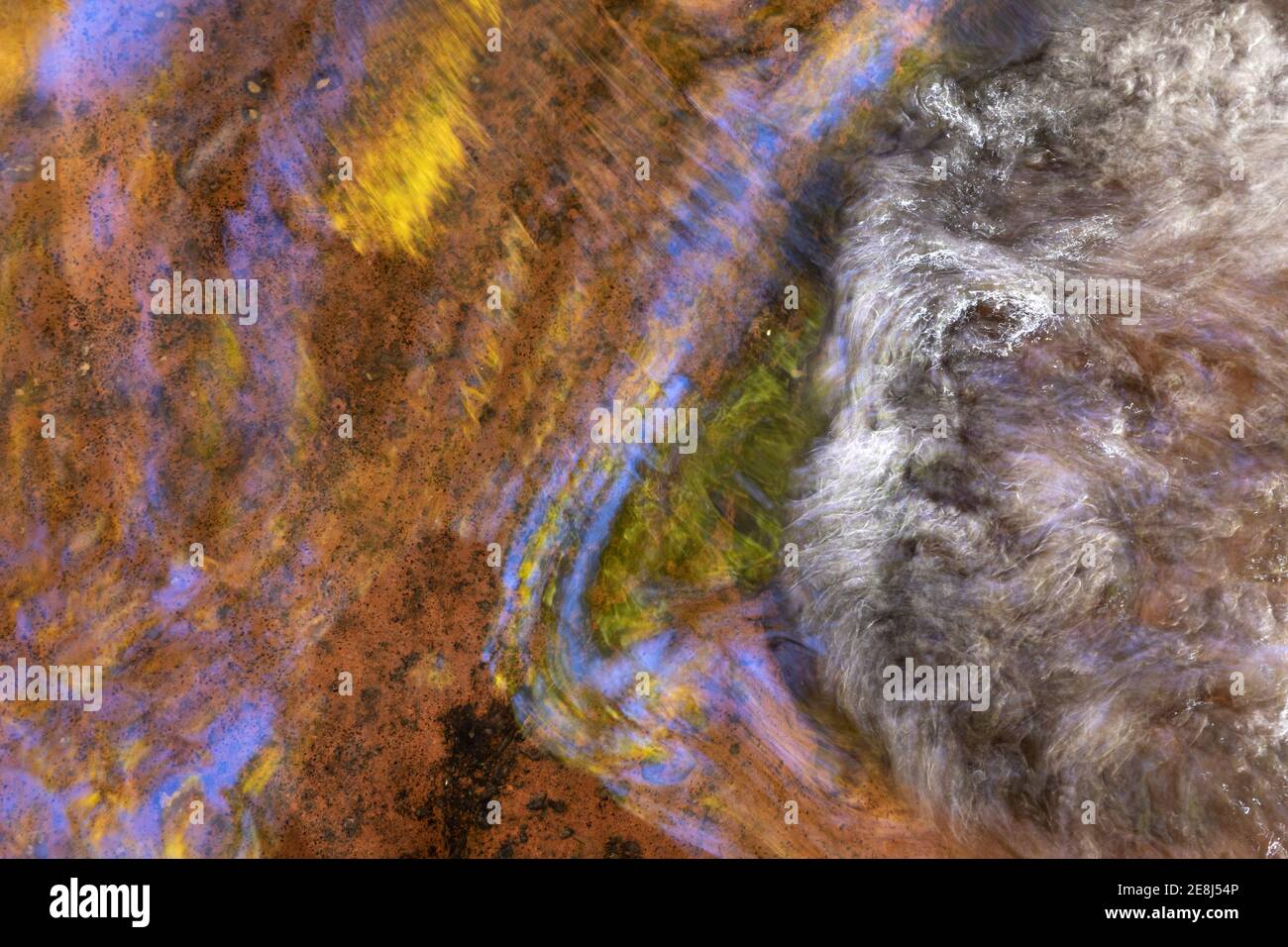 Top view splashing waves of shallow seawater reflecting blue and yellow ...