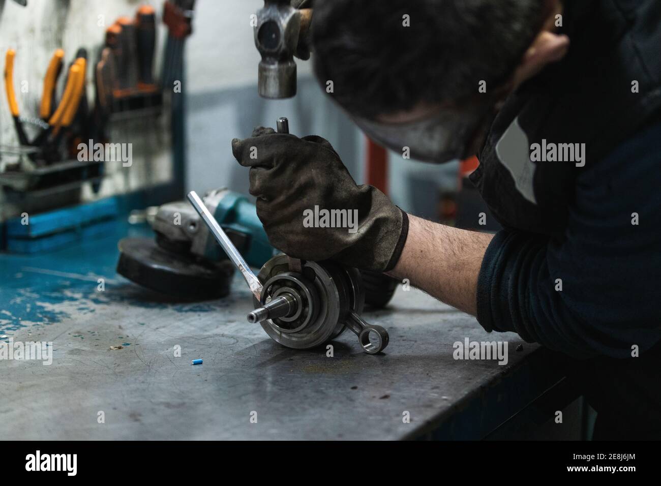 Side view of concentrated adult male auto mechanic in protective ...