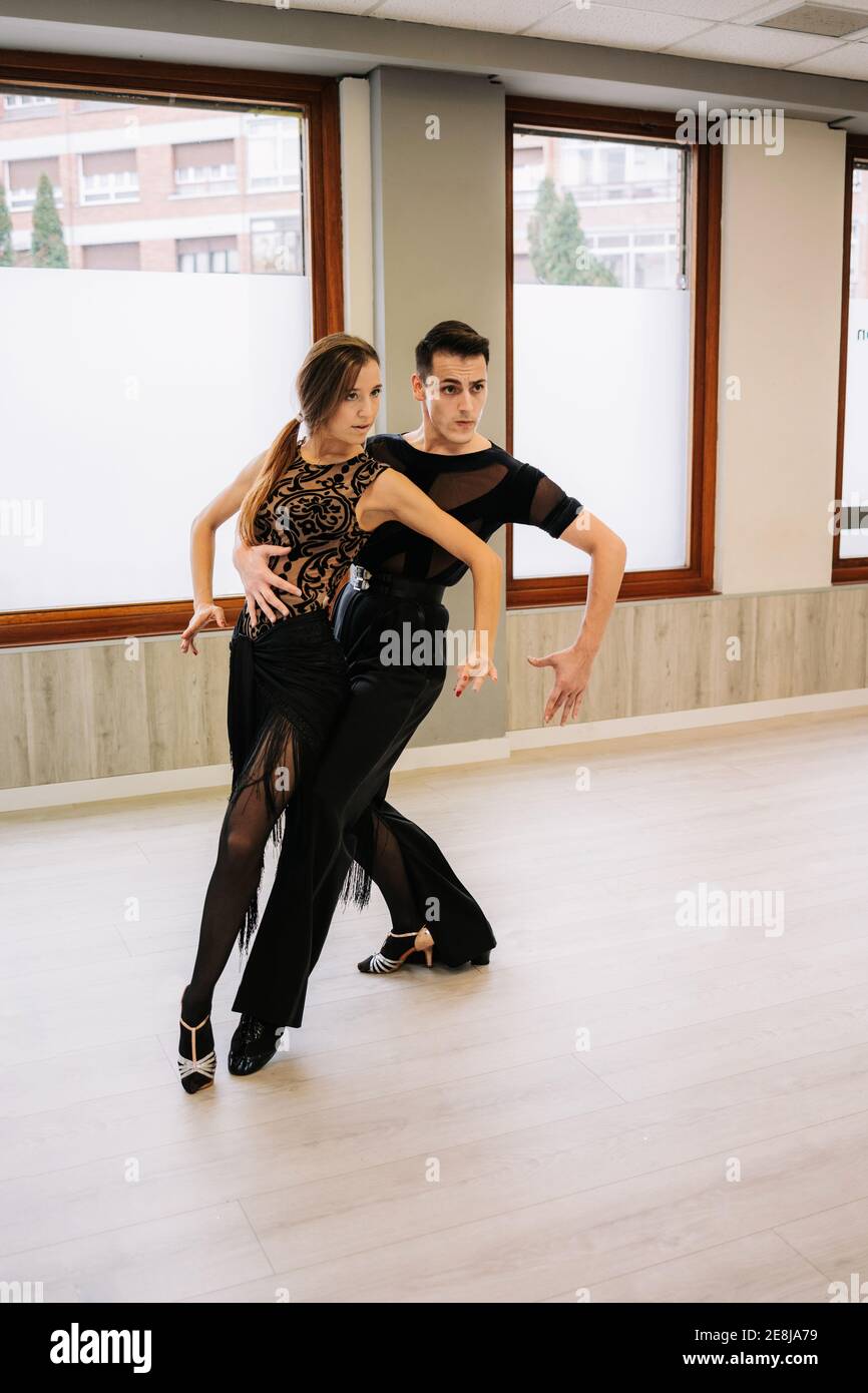 Couple of talented dancers moving gracefully while rehearsing ballroom ...