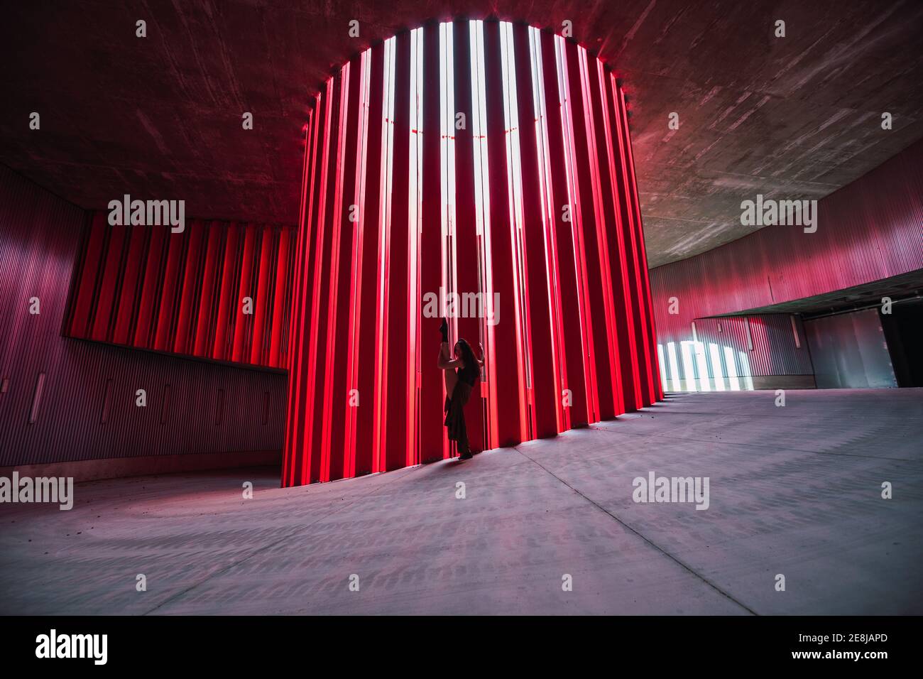Side view of anonymous female theater artist stretching leg while ...