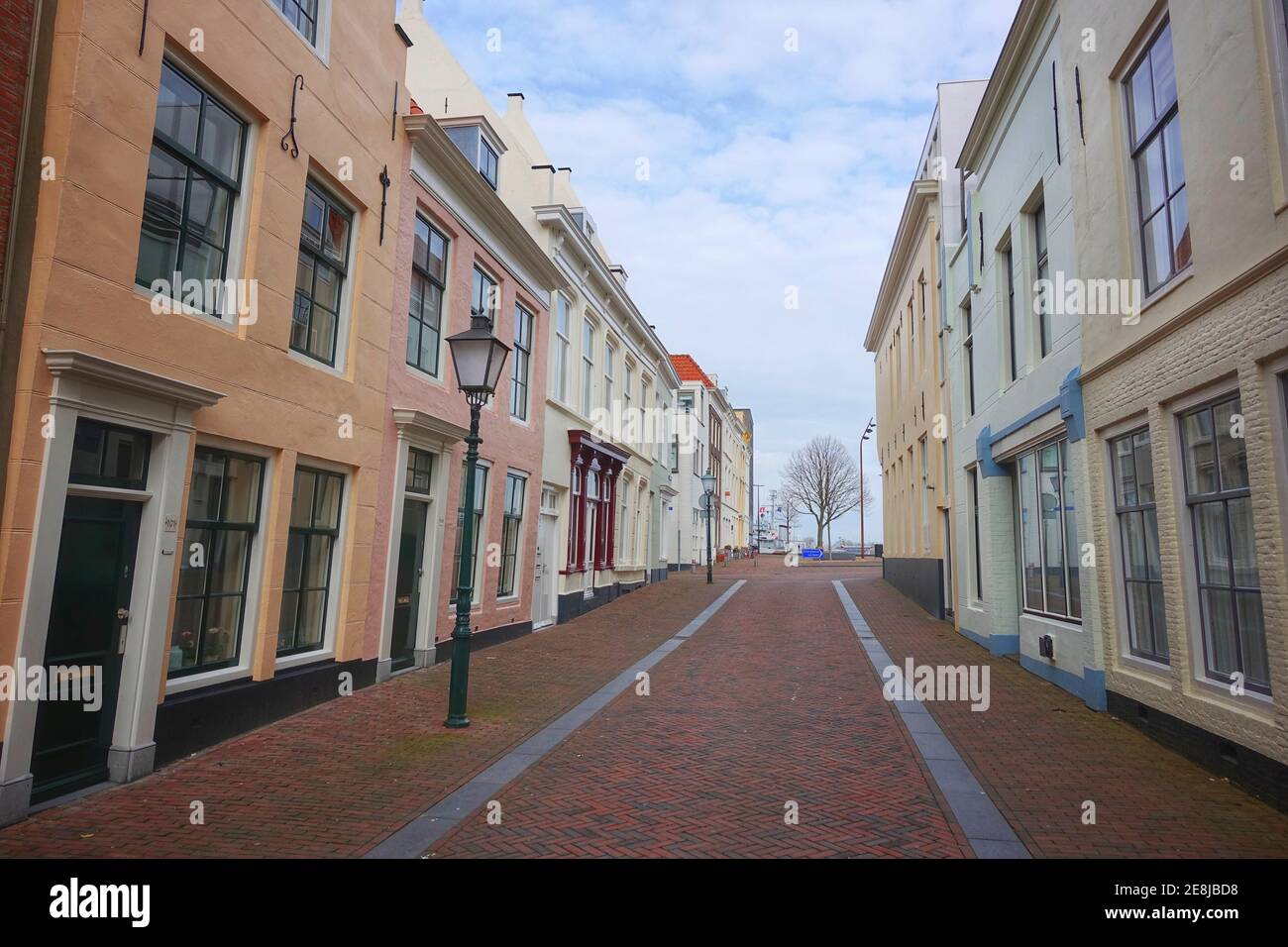 A low angle shot of a street with 2-story buildings captured during the ...