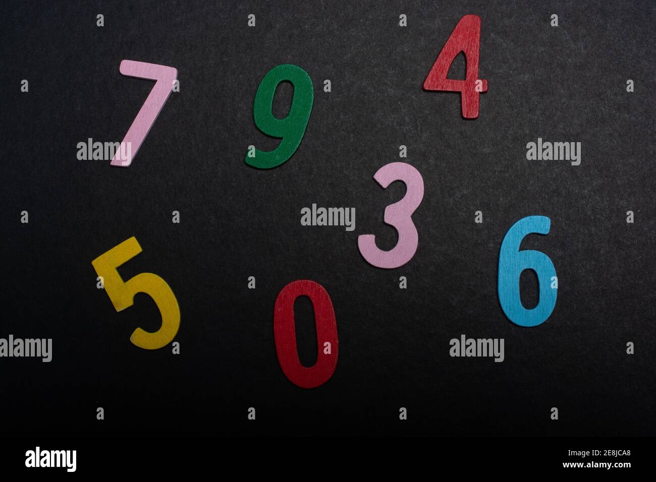 The wooden colorful various numbers on the black surface Stock Photo ...