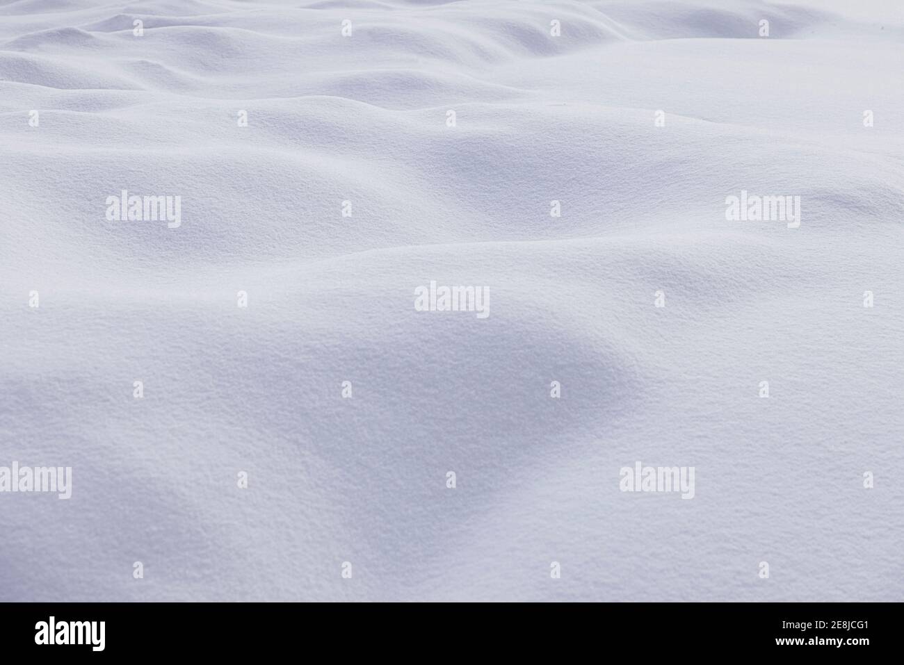 Textured backdrop of snowy terrain with white bumpy surface in winter ...