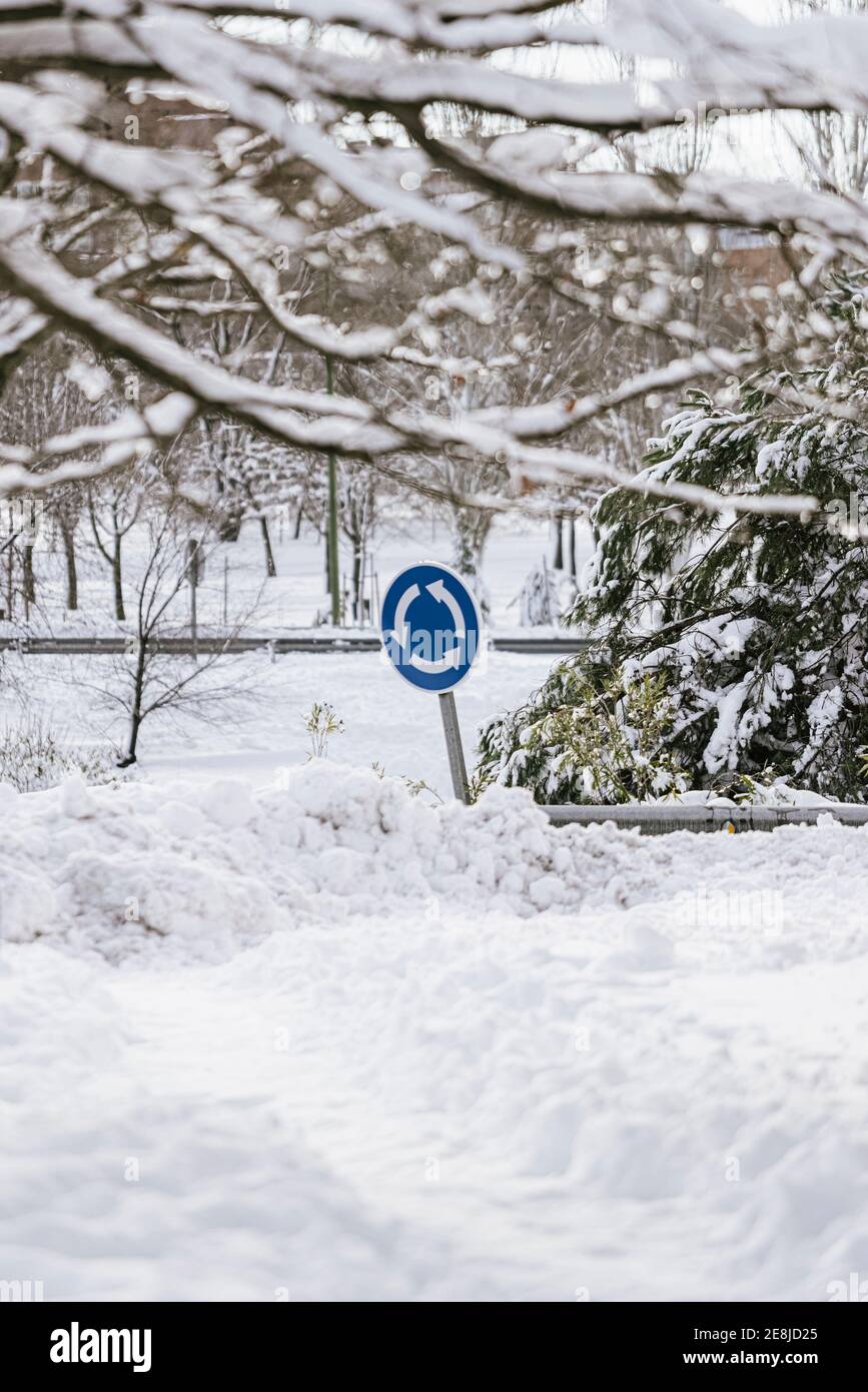 Blue road sign showing roundabout symbol near wavy pathway against ...